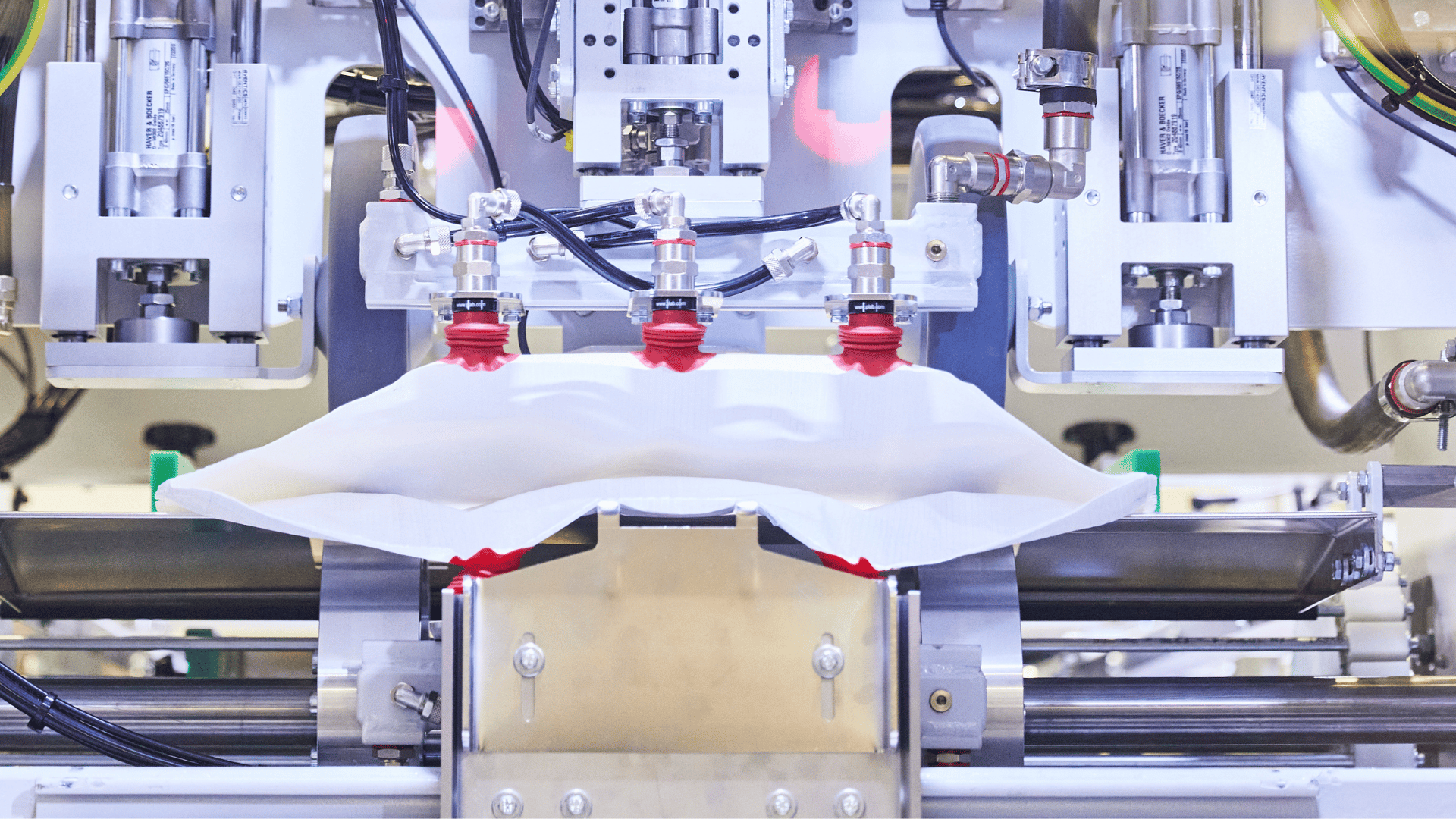 Packing machines for pre-formed open-mouth bags